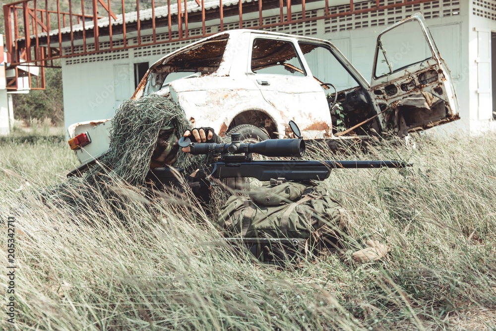 Sniper in urban combat training. Full ghillie camo suit and a high ...