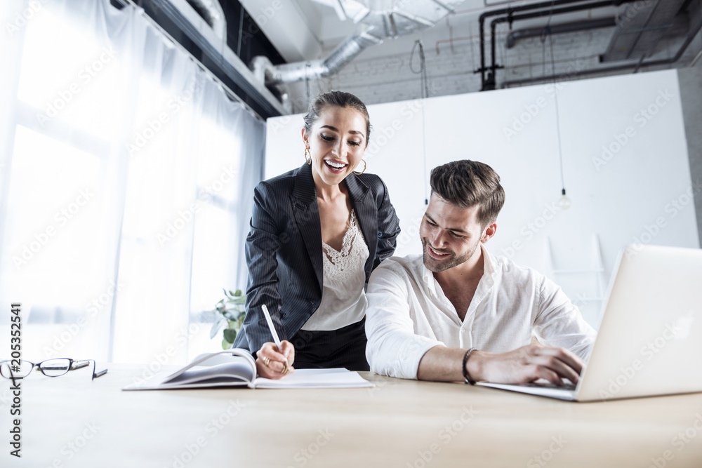 Coworkers on a project working together on the same workstation ...