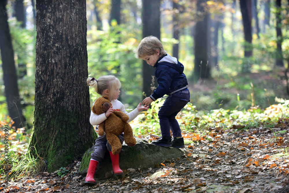 Little boy and girl friends camping in woods. Children play in autumn ...