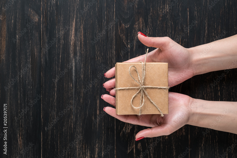 Hand of a young girl opening a gift box on a dark background. Stock ...