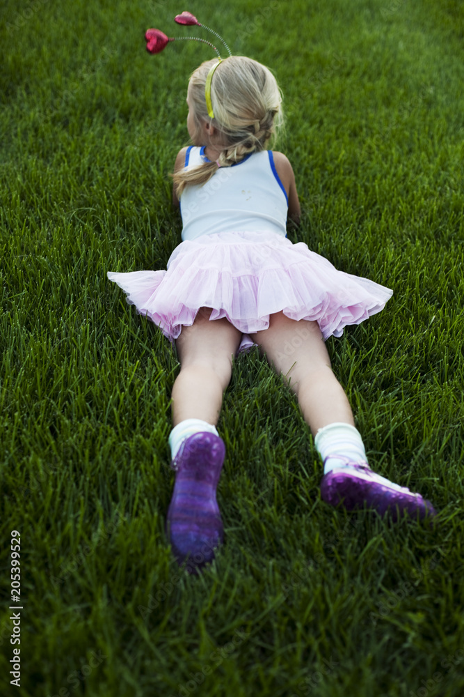 Little Girl Laying In Grass