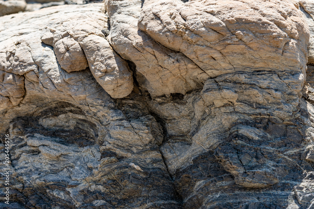 Compressed rock layers formation in various colors and thicknesses, on ...