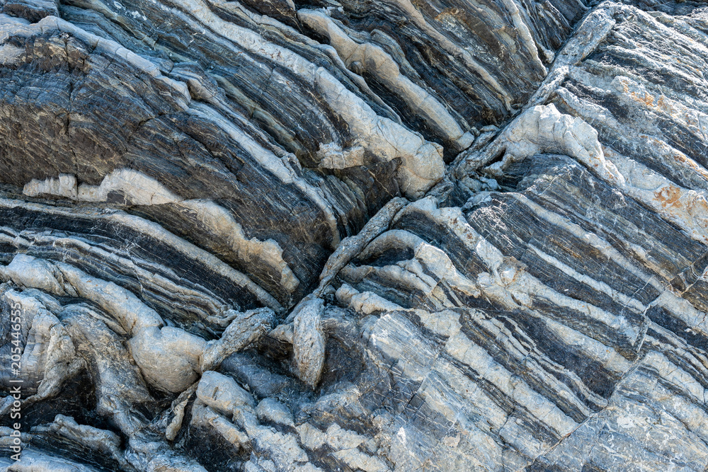 Compressed rock layers formation in various colors and thicknesses, on ...
