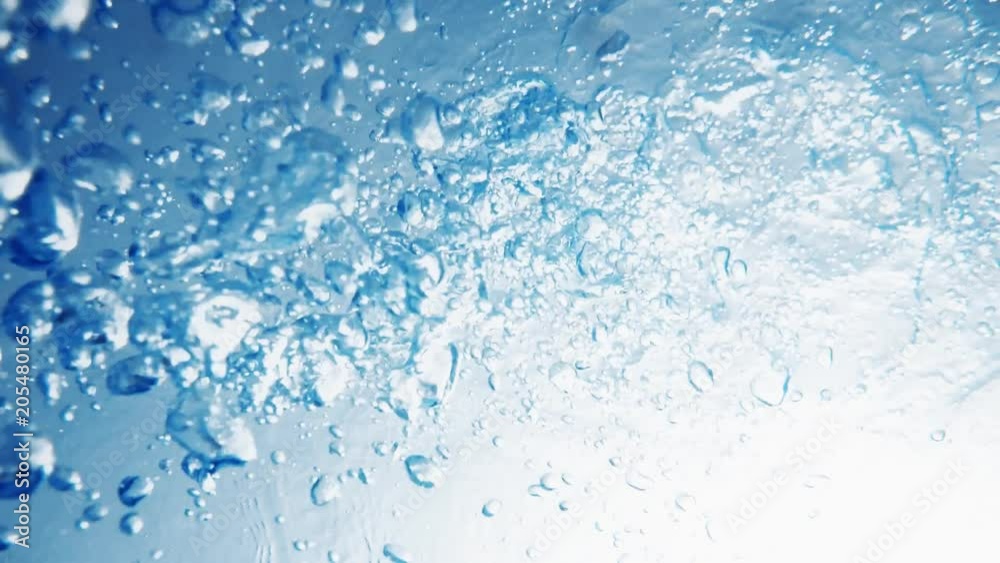 Air bubbles rising up to surface in blue pure ocean. Sunshine ...