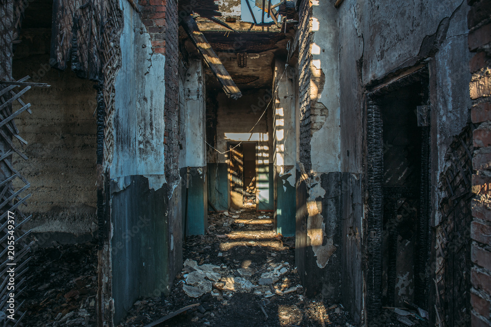 Ruins of burned brick house after fire disaster accident. Corridor ...