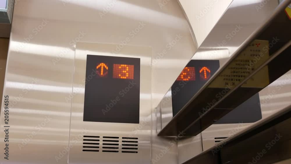 Motion of people taking elevator from one to eight floor inside ...