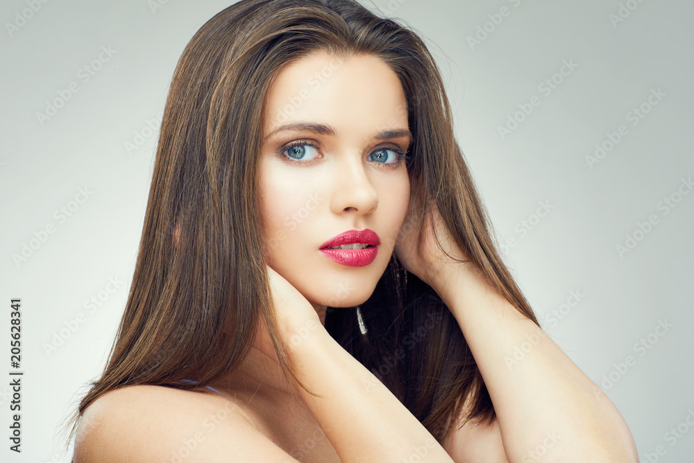 Girl touching long hair with hand. Stock Photo | Adobe Stock