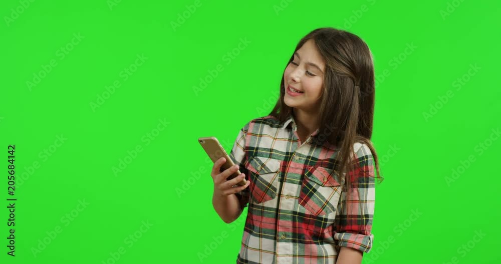 Adorable small teen girl with long fair hair and in the motley shirt ...