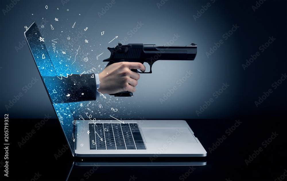 Hand with gun coming out of a laptop with sparkling effects foto de ...