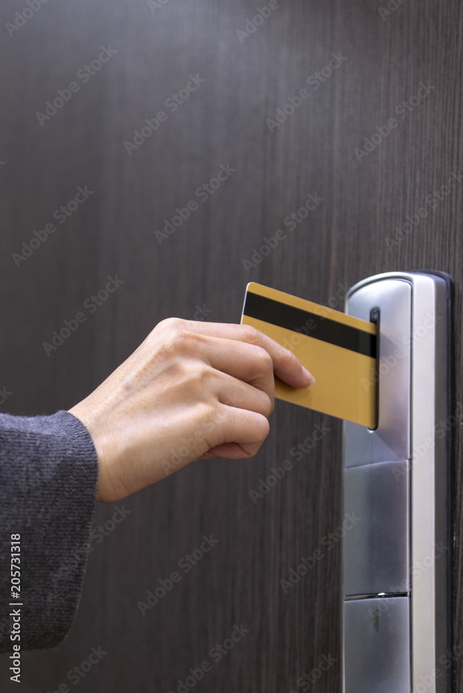 Hotel door - woman's hand inserting a magnetic stripe hotel key card in ...