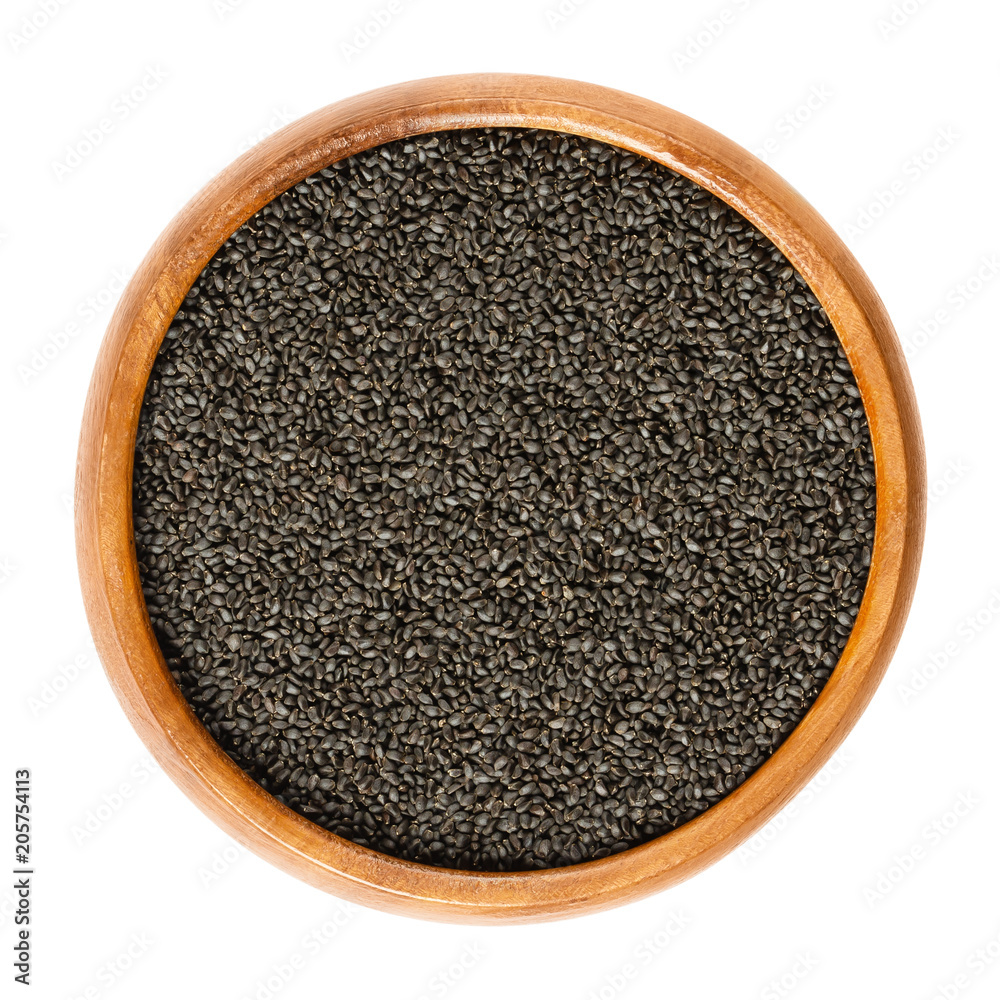 Dried basil seeds in wooden bowl. Also great basil. Ocimum basilicum ...