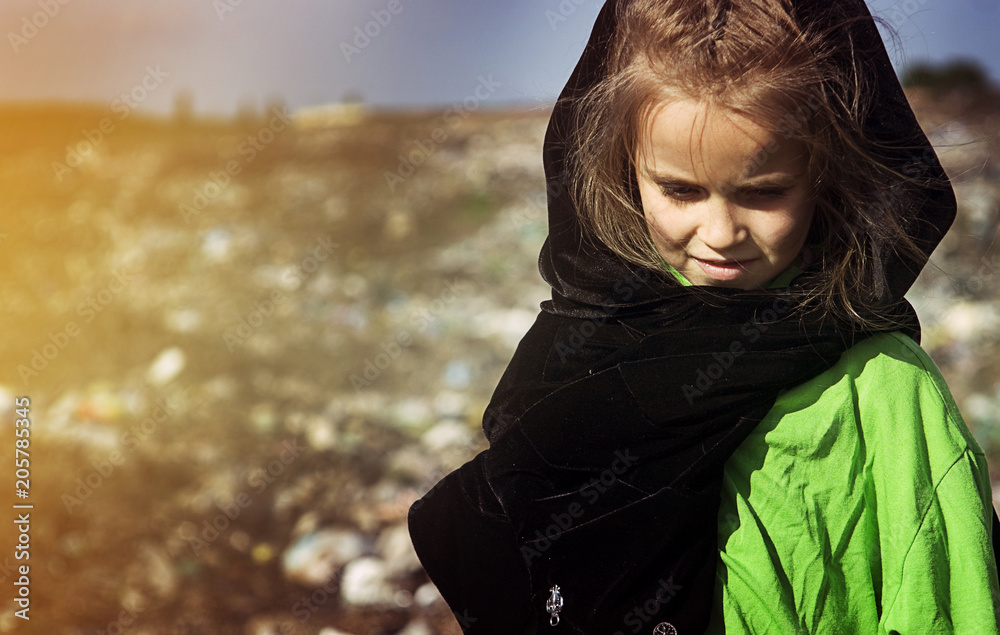 Homeless little girl with a cape on her head in a garbage dump Stock ...