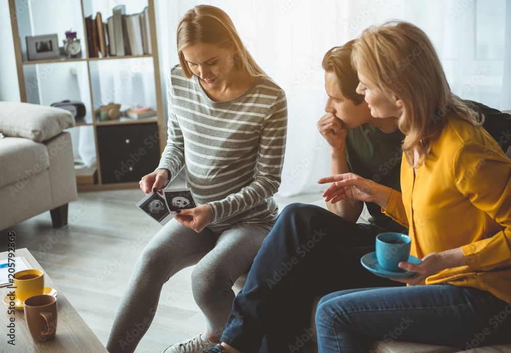 Expecting new life together. Cheerful surrogate expectant mother is ...