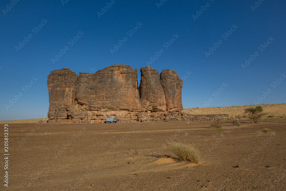 Camp with 4x4 expedition verhicle at massive rock formation ...