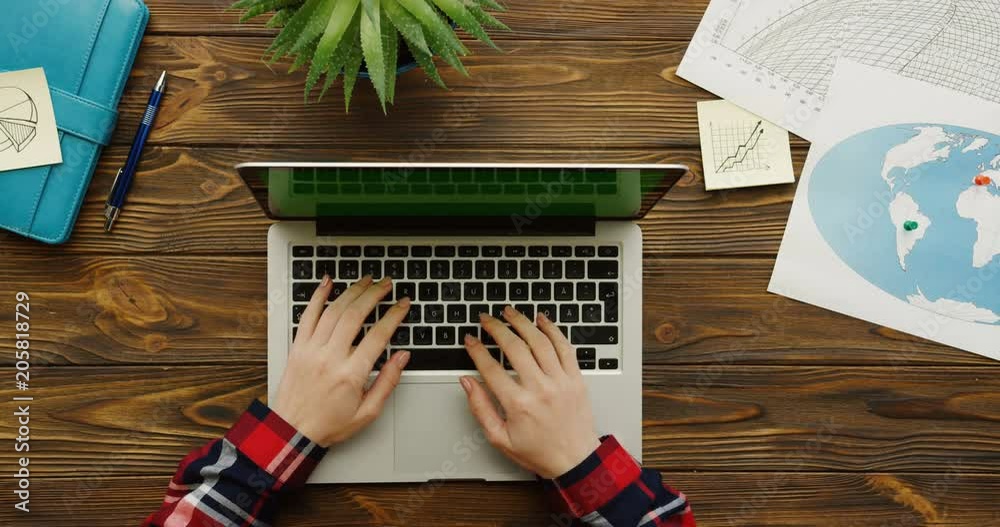 Close up of the female hands with the plaid sleeves working on the ...