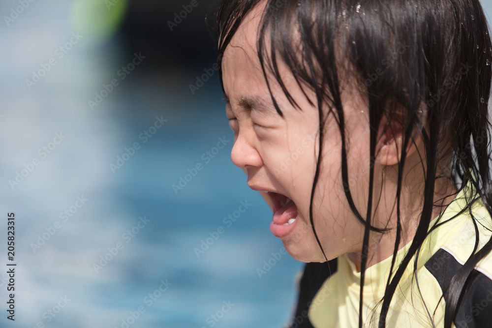 Asian Little Chinese Girl crying in Swimming Pool Stock Photo | Adobe Stock