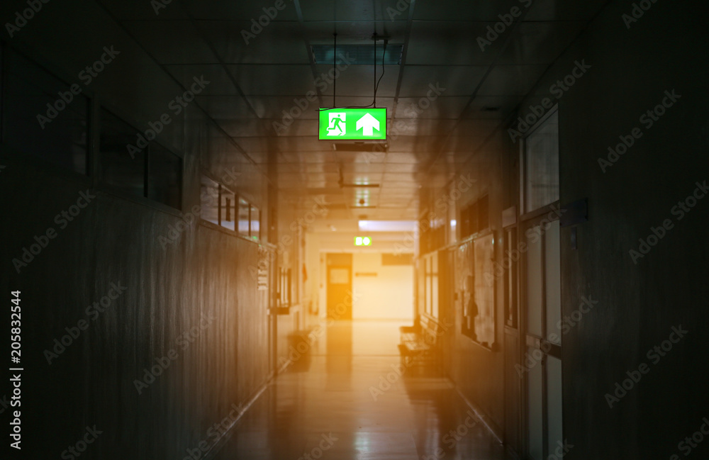 Emergency exit sign with fire in the building. Stock Photo | Adobe Stock
