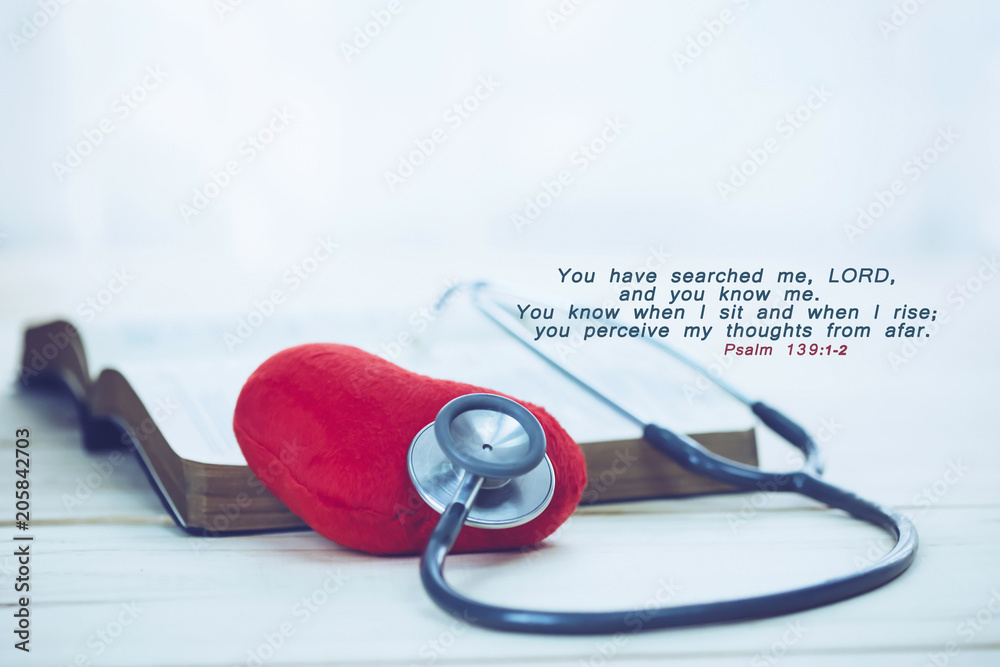 stethoscope over the red heart and the open bible with bible verses ...