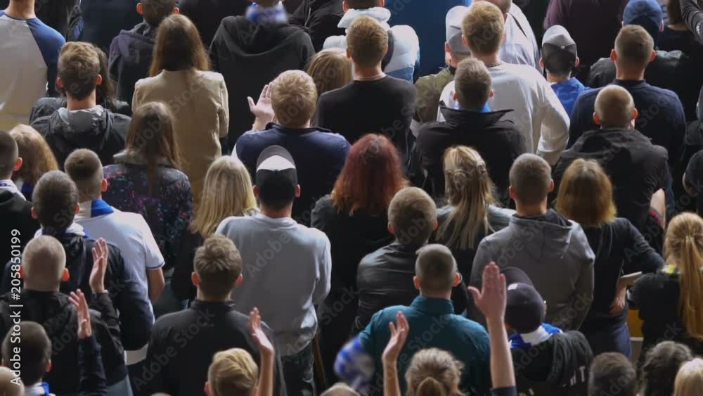 Disappointed fans waving, gesturing at football referee, foul play ...