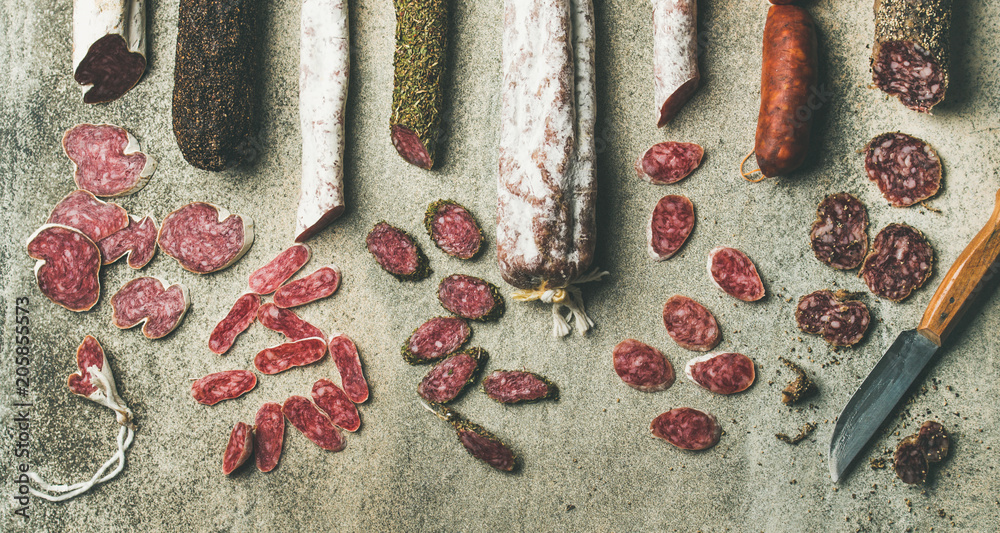 Variety of Spanish or Italian cured meat sausages. Flat-lay of fuets ...