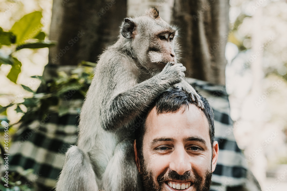 .Young handsome man taking himself some pictures with a cute monckey in ...