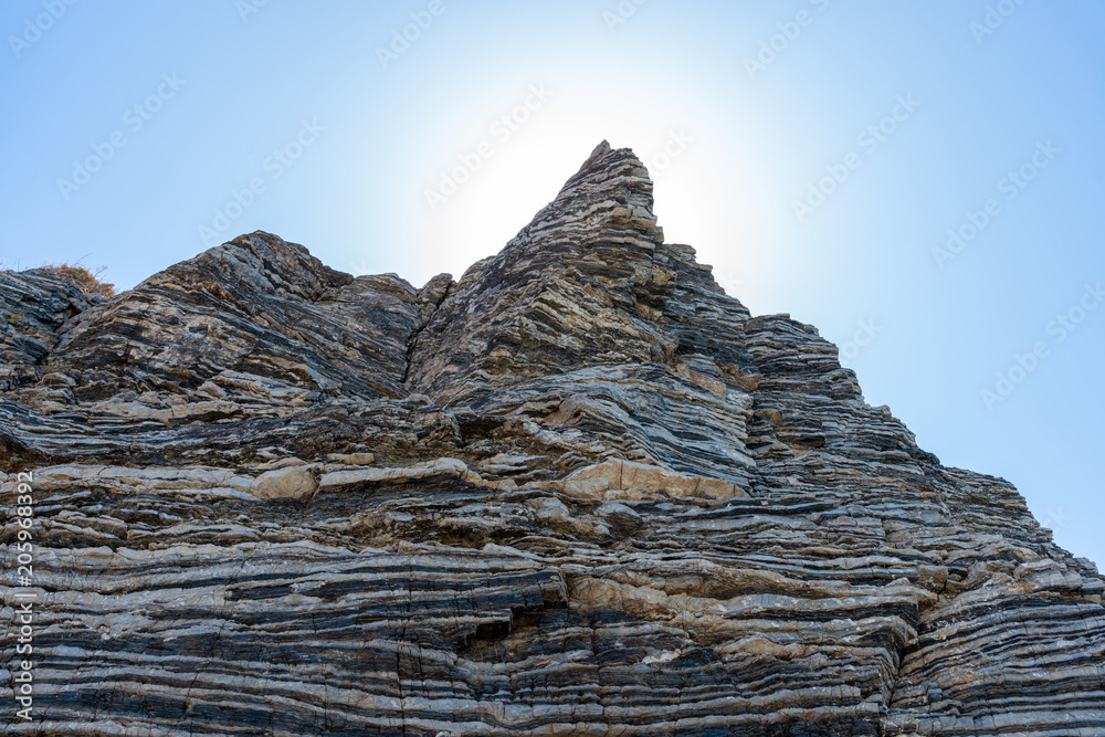 Compressed rock layers formation in various colors and thicknesses, on ...