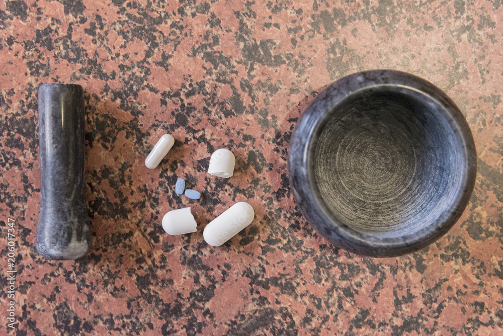 Mortaio con pestello e pillole su tavolo in granito Stock Photo | Adobe ...