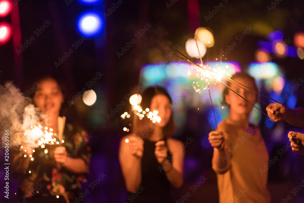 Blurred of Sparklers with group of friends having fun for celebration ...