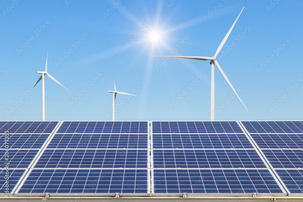 Rows array of polycrystalline silicon solar panels and wind turbines ...