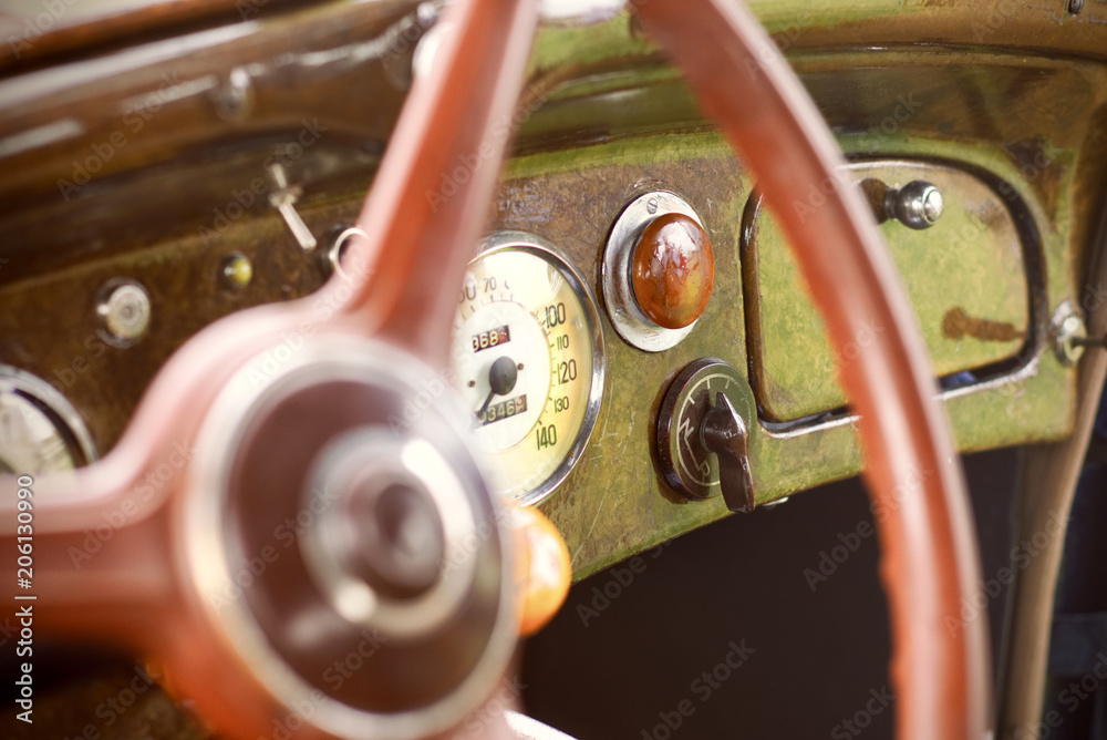 Poster Vintage car cockpit with wooden dashboard and blurry steering ...