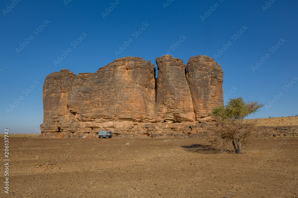 Camp with 4x4 expedition verhicle at massive rock formation ...