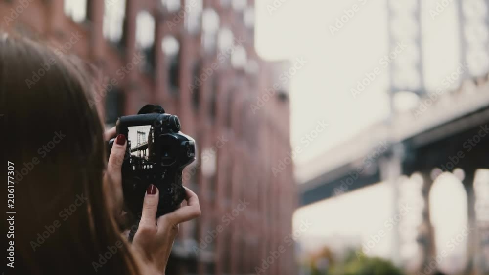 Back view unrecognizable woman with camera takes photos of Brooklyn ...
