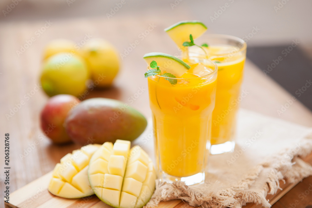 Fresh mango smoothie in glass with fruits on the wooden table Stock ...