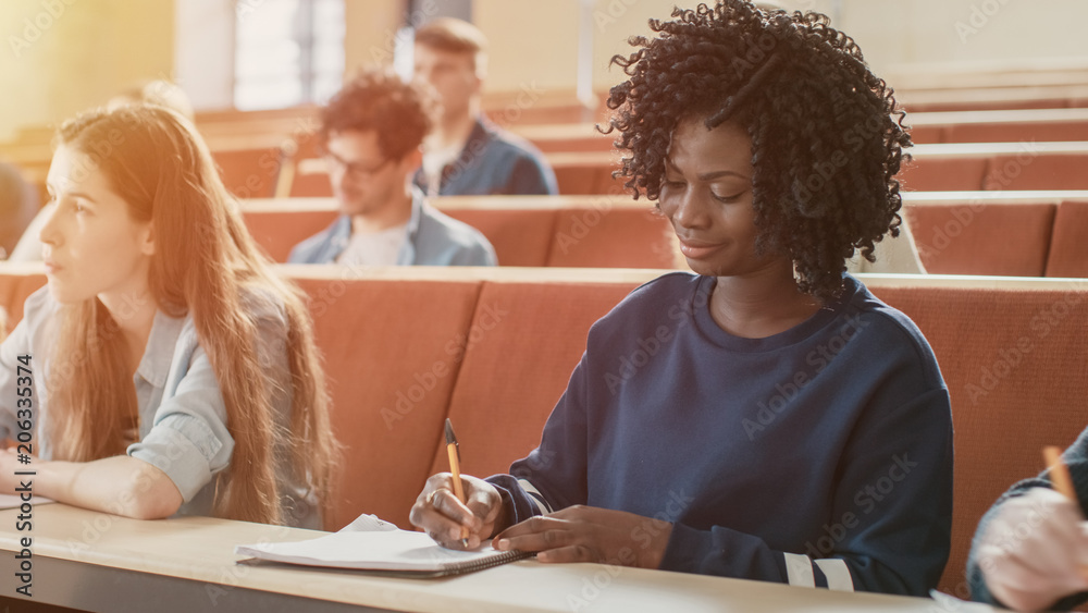 Beautiful Black Female Student Sitting Among Her Fellow Students in the ...