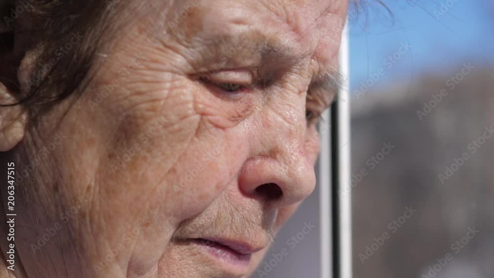 Vidéo Stock Closeup Of The Sad Face Of An Old Woman Suffering From ...