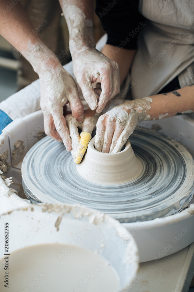 Handcrafted on a potter's wheel,Hands make clay from various items for ...