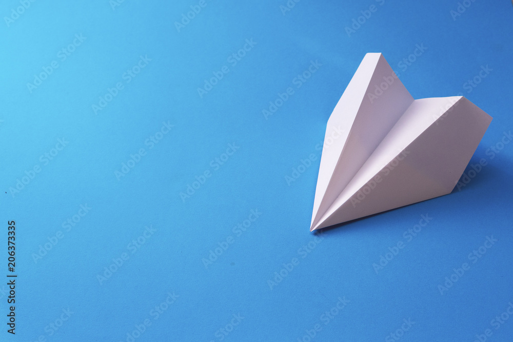 paper plane on blue background Stock Photo | Adobe Stock