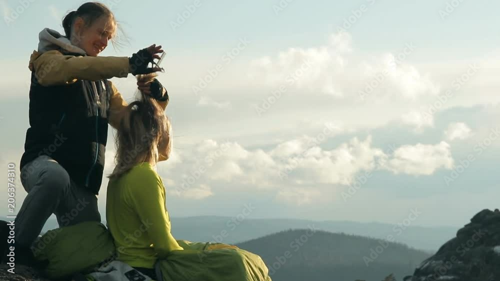 Extreme haircut on top of the cliff. Young male hairdresser doing a ...