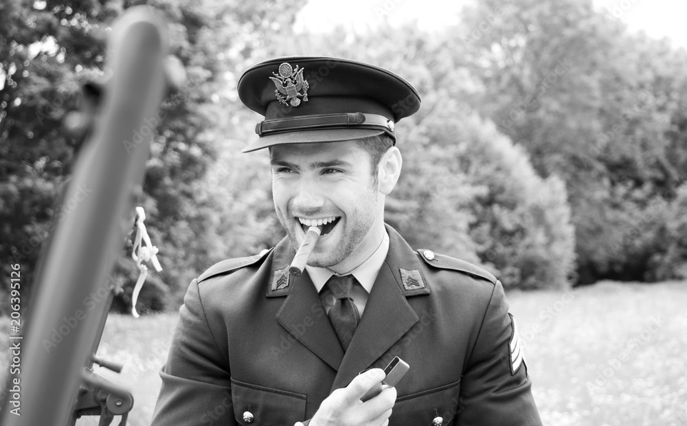 Handsome American WWII GI Army officer in uniform smoking cigar next to ...