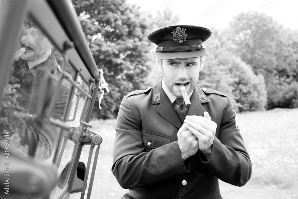 Handsome American WWII GI Army officer in uniform smoking cigar next to ...