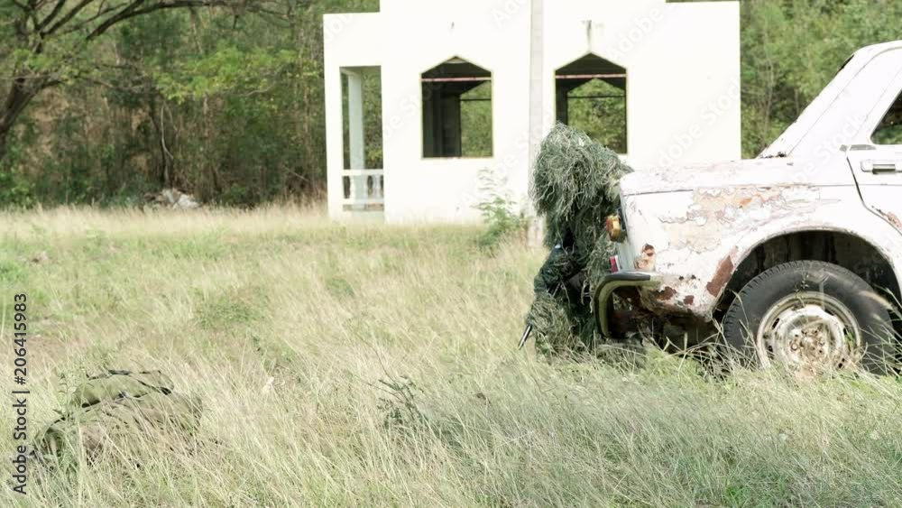 Sniper preparing his sniper rifle in urban combat training ground ...