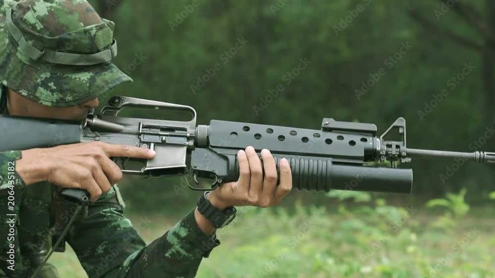 Slow motion of soldier reloading his weapon. Chinese soldier reloading ...