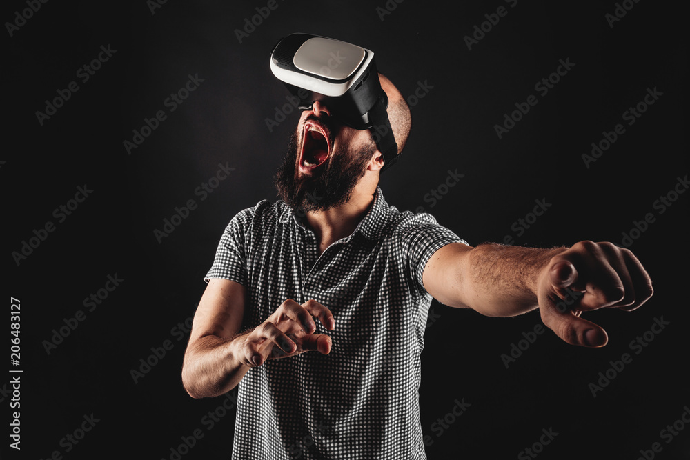 bearded man touching the air and screaming during the VR experience ...