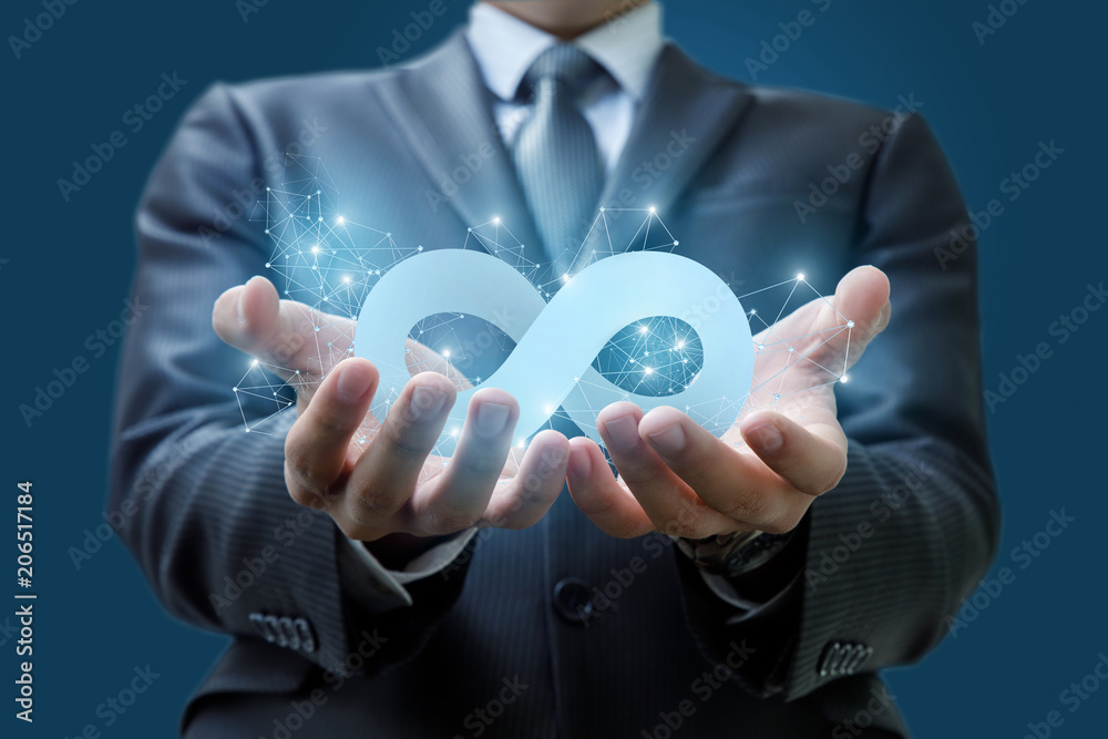 Businessman shows the infinity symbol. Stock Photo | Adobe Stock