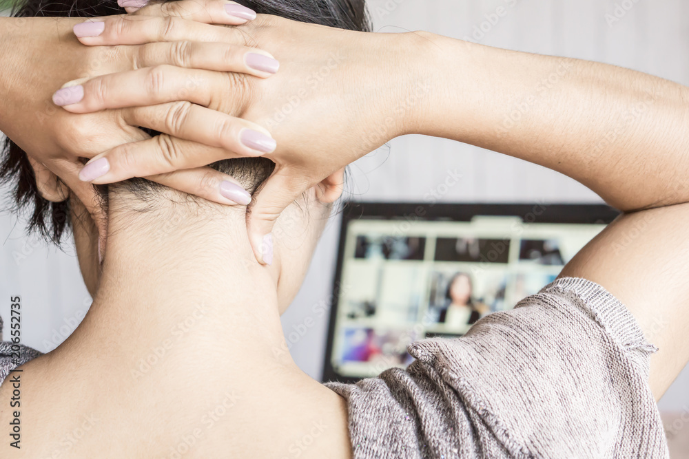 business Asian woman massaging neck pain while working on computer ...