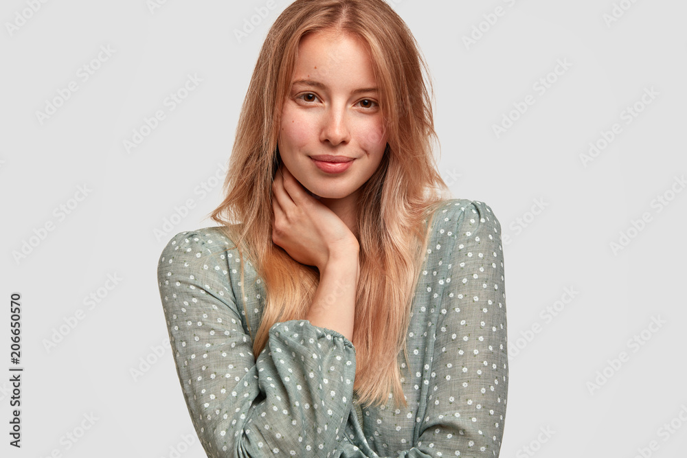 Pleased attractive Caucasian female has appealing apperance, dressed in ...