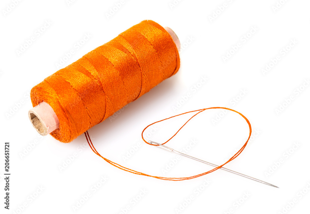 spool of thread with a needle Stock Photo | Adobe Stock