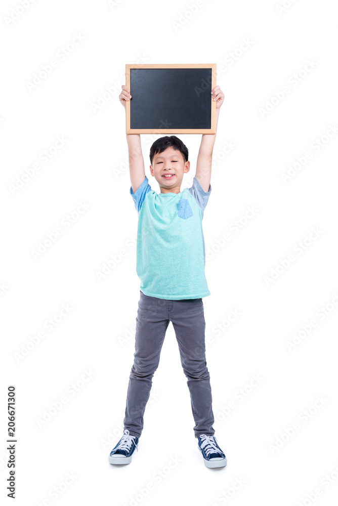 Young asian boy holding chalkboard and smiles over white background ...
