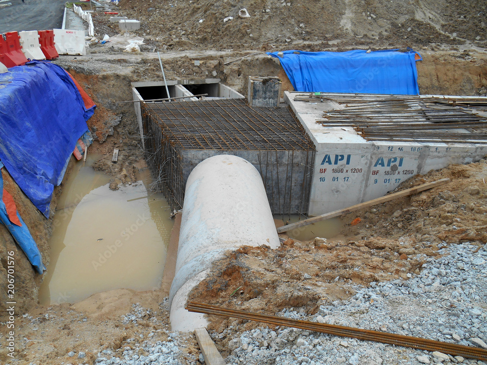 Underground drainage manhole under construction by construction workers ...
