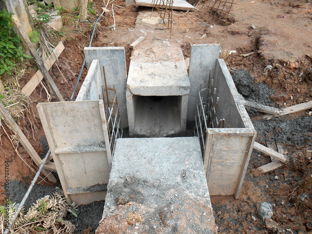 Underground drainage manhole under construction by construction workers ...